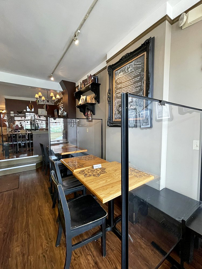 The cozy interior balances rustic charm with urban cool - wooden tables, elegant framing, and just enough space to feel intimate without crowding your elbows.