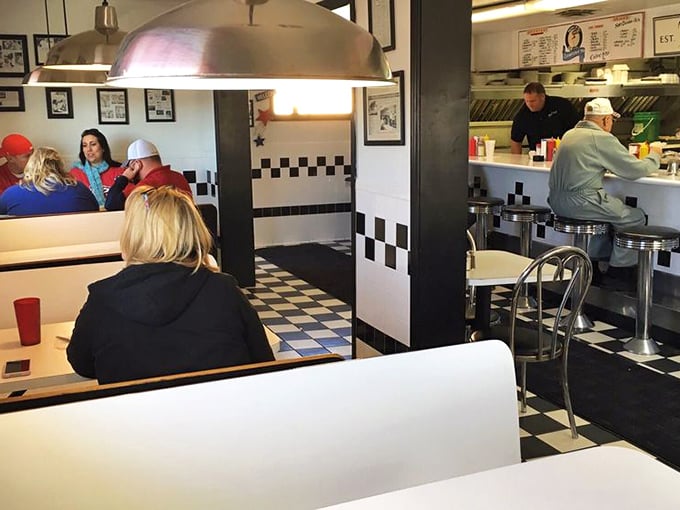 Classic black and white checkered floors set the stage for culinary time travel. This isn't decoration&mdash;it's a portal to simpler times.