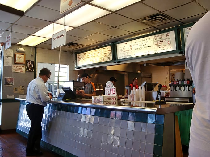 Behind this blue-tiled counter, burger alchemy happens daily. No fancy molecular gastronomy needed&mdash;just decades of flat-top wisdom.
