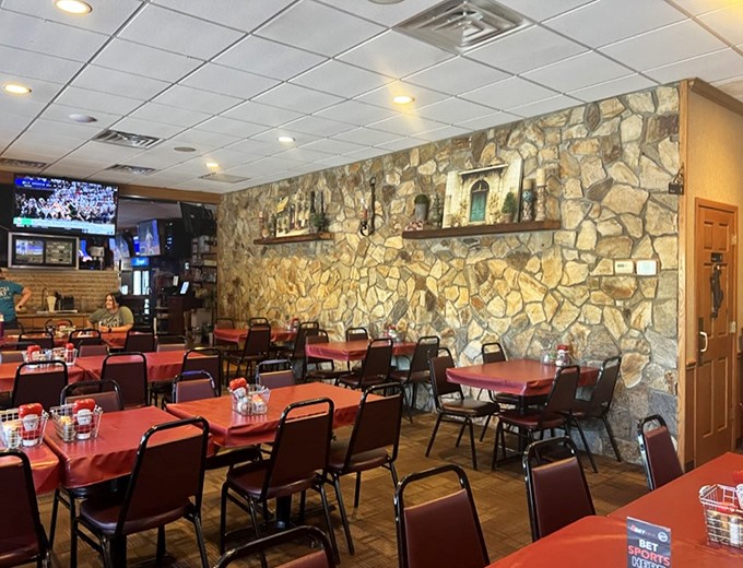 Stone walls and wooden tables create that perfect "neighborhood joint" atmosphere. The kind of place where comfort food and conversation flow equally well.