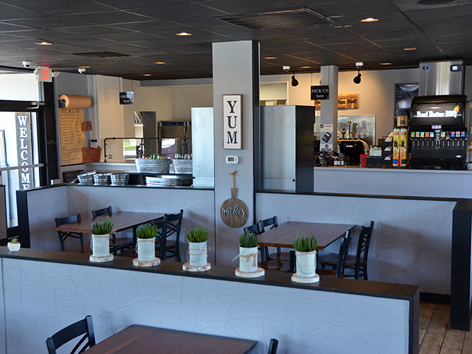 Clean lines, potted greenery, and that "YUM" sign that speaks the universal truth about what's about to happen to your taste buds.