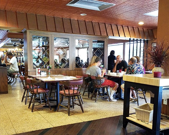 Inside, warm wood tones and classic diner seating create that perfect "everybody knows your name" atmosphere where conversations flow as freely as the coffee.