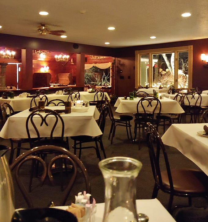 Classic ice cream parlor chairs meet crisp white tablecloths&mdash;a dining room that whispers "we're serious about food, not formality."