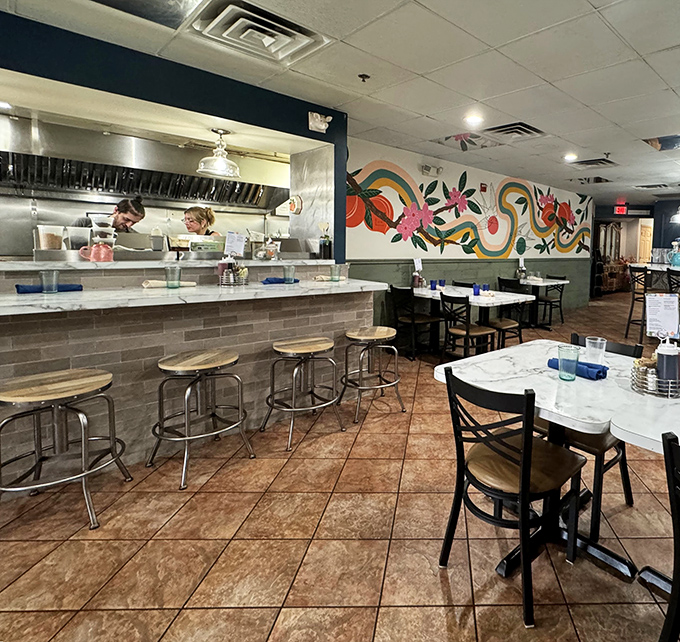 Where breakfast dreams come true &ndash; an open kitchen, vibrant mural, and marble tabletops create the perfect stage for morning magic.