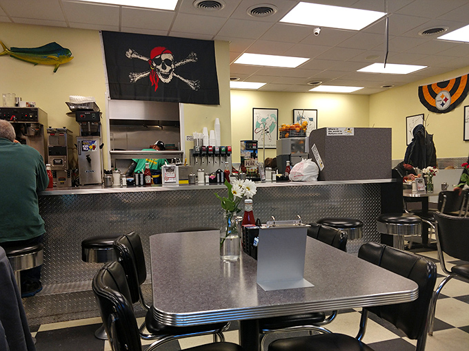 Classic diner interior where chrome meets comfort, and that pirate flag watches over your cholesterol choices with zero judgment.
