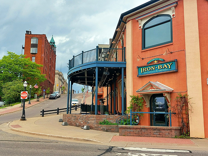 The Iron Bay Restaurant's distinctive blue balcony isn't just architectural flair—it's prime real estate for watching Lake Superior's mood swings.