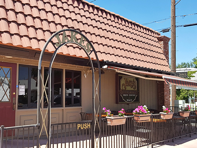 Jake's Steakhouse welcomes you with terra cotta charm and flower boxes that say "come for the steak, stay for the ambiance."