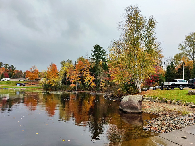 Nature's autumn masterclass in color theory &ndash; where every fiery maple and golden birch gets a standing ovation in the lake's perfect mirror.