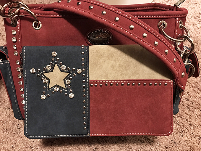 Texas pride you can carry! This leather handbag featuring the Lone Star State flag proves everything really is bigger and bolder in Texas.