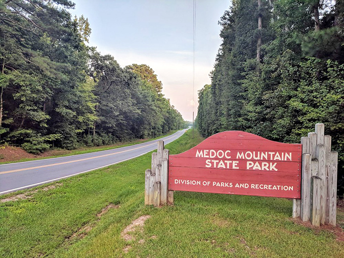 The unassuming red welcome sign stands like a humble ma&icirc;tre d' at nature's finest restaurant. No reservation needed&mdash;just an appetite for adventure.
