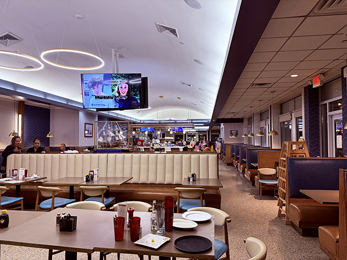 The interior strikes that perfect balance between modern comfort and nostalgic diner charm. Those circular light fixtures? Pure genius.