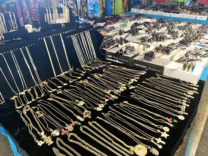 Gold chains and pendants glisten under fluorescent lights like an Ali Baba cave relocated to Alabama. Each necklace waits patiently for its next chapter.