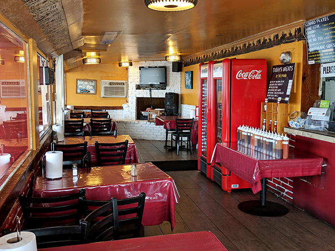 Red vinyl tablecloths, simple wooden chairs, and that vintage Coca-Cola refrigerator create the perfect backdrop for serious BBQ consumption.