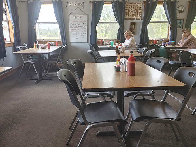 Simple tables, navy curtains, and the promise of seafood magic. This dining room doesn't need fancy frills when the food does all the talking.