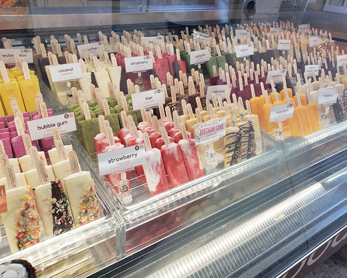 A rainbow of frozen treats at Popbar offers sweet salvation from Florida's heat. Strawberry, coconut, and kiwi popsicles standing at attention like colorful soldiers.