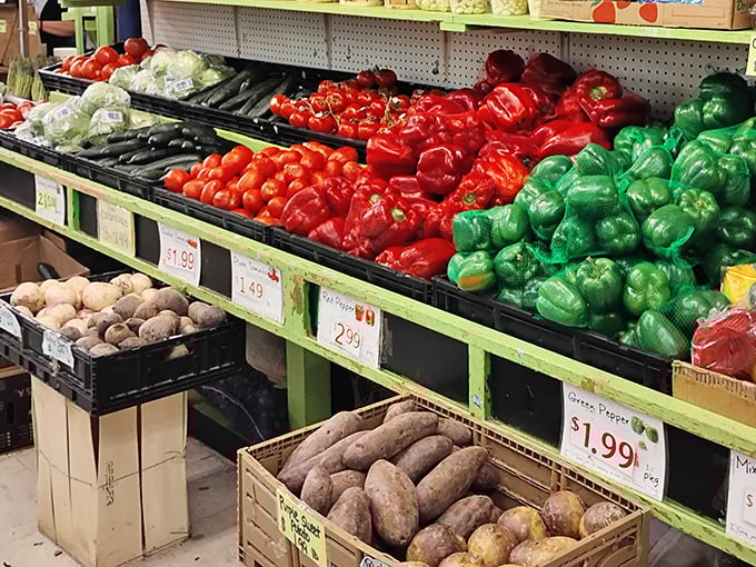 Nature's color palette on full display! These peppers and produce aren't just fresh&mdash;they're practically having a beauty pageant on those green shelves. 