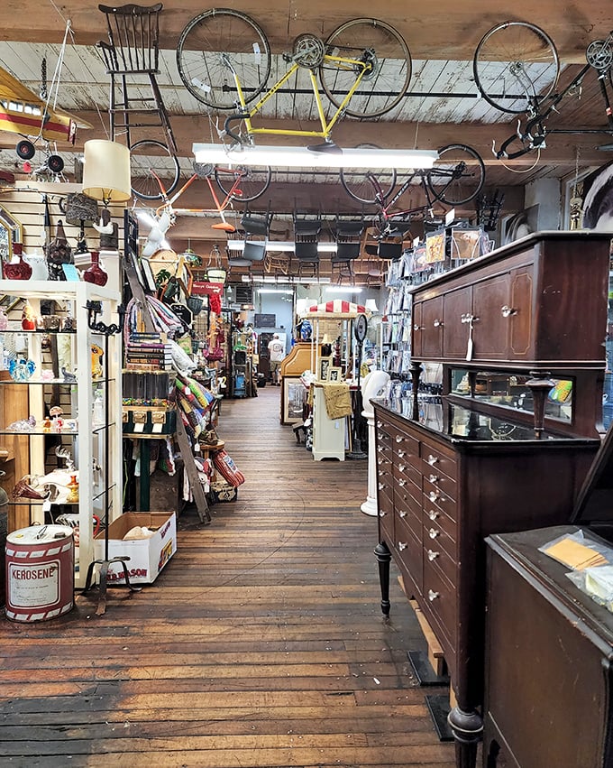 Wooden floors creak beneath your feet as you navigate aisles where bicycles hang from ceilings and antique cabinets hold mysteries in every drawer.