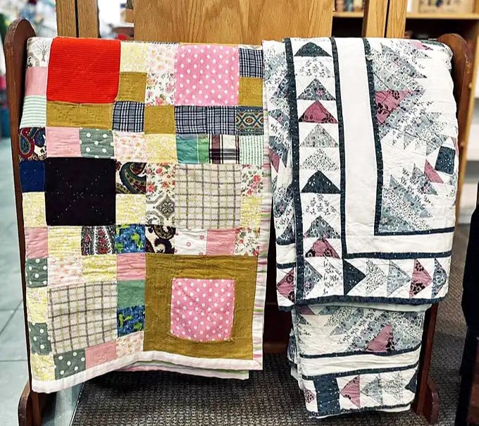 Handcrafted quilts tell stories of patience and artistry, each patch a chapter waiting to adorn someone's guest bedroom or reading nook.