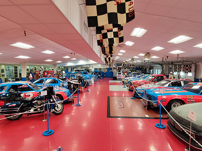 NASCAR heaven under one roof. The museum's vibrant red floor creates the perfect runway for these legendary racing machines.
