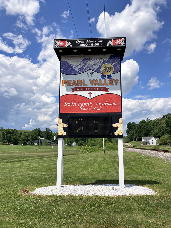Under blue Midwestern skies, this sign stands as a dairy lighthouse guiding hungry travelers to cheese paradise. Note the "Award Winning" badge&mdash;they're not kidding.