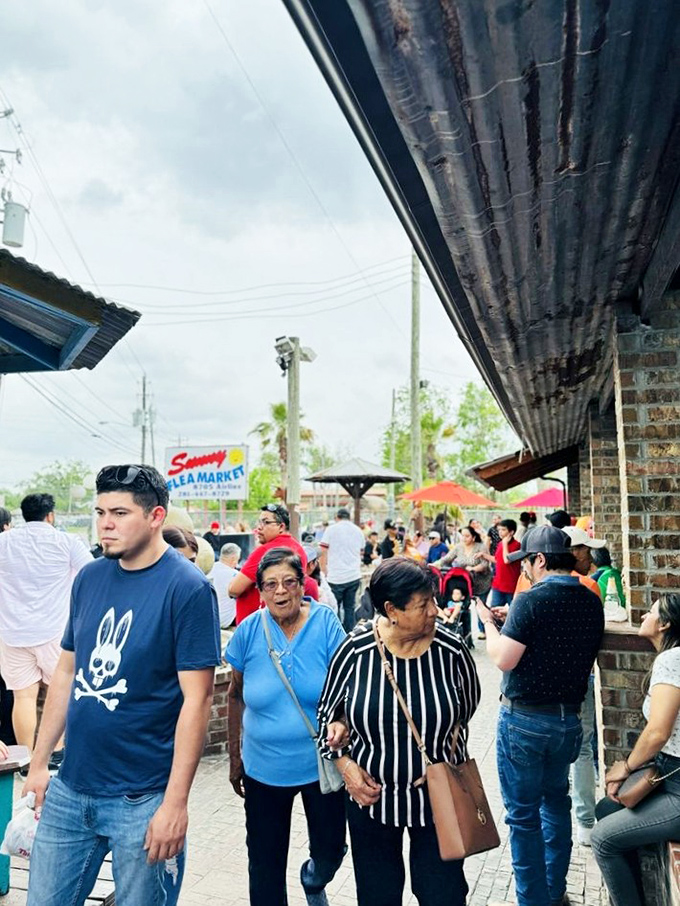 The weekend crowd navigates the market's bustling pathways. Multi-generational families on the hunt for treasures, each with their own mission and shopping strategy. 