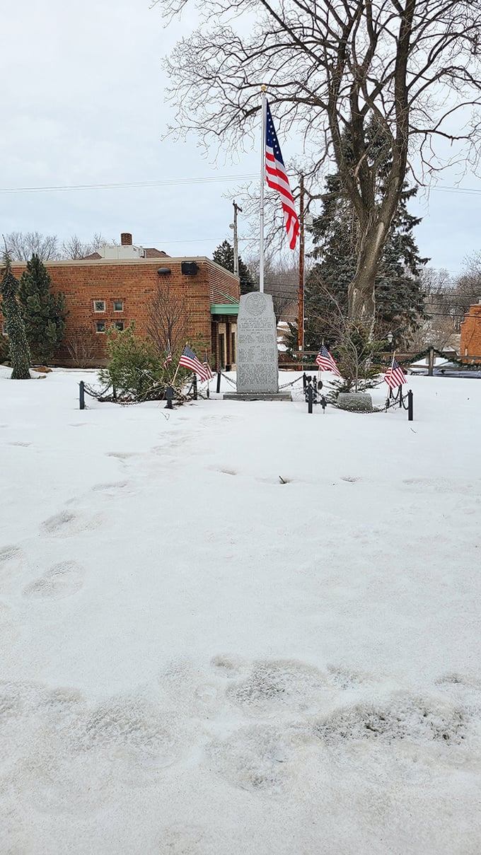 Even under winter's blanket, Mineral Point's memorial grounds stand as a testament to history, with flags proudly waving against the stark landscape.