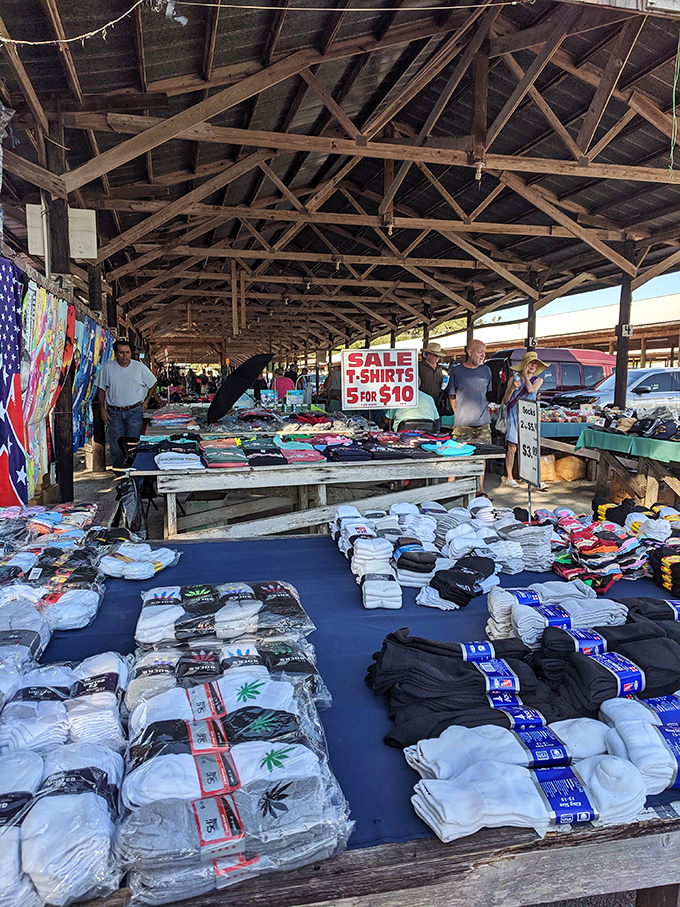 T-shirt paradise or fabric fever dream? Under these rustic wooden beams, $10 gets you five new wardrobe options and a story to tell.