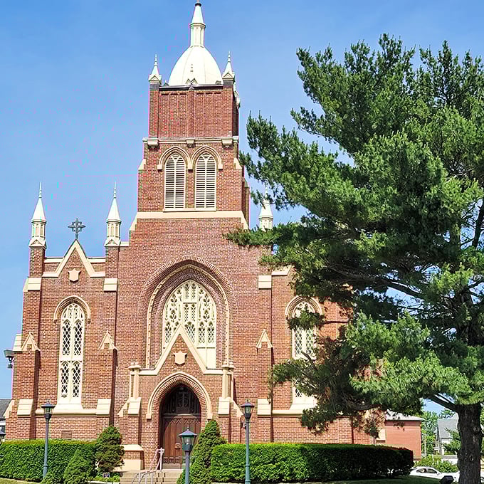 St. Vincent Catholic Church stands majestically against the blue sky, its brick tower a beacon of Gothic splendor.