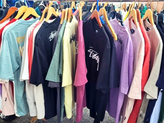 The T-shirt rainbow! Every color of the spectrum hangs ready for the taking, proving Hawaii's fashion philosophy: life's too short for boring shirts.