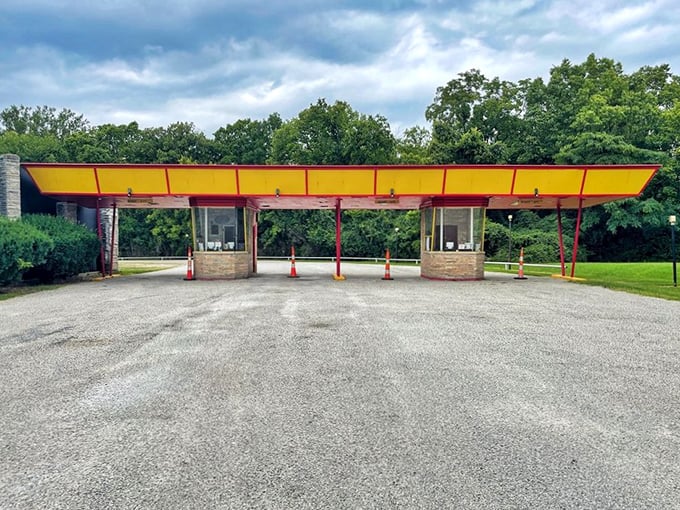 The iconic yellow and red entrance booths stand like cheerful sentinels, welcoming generations of moviegoers to their evening escape.
