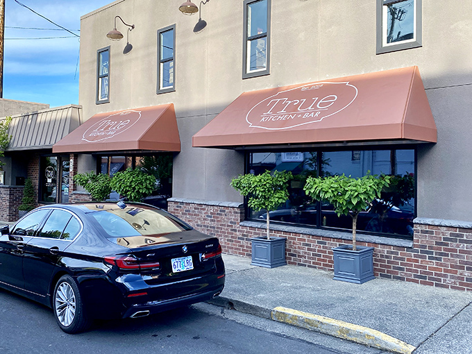 True Kitchen + Bar's inviting awnings promise culinary adventures within &ndash; comfort food with a sophisticated twist awaits.