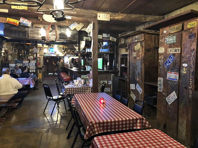 Red checkered tablecloths and license plate-covered walls create the perfect backdrop for meat-centric memories. No interior decorator needed, just decades of character.