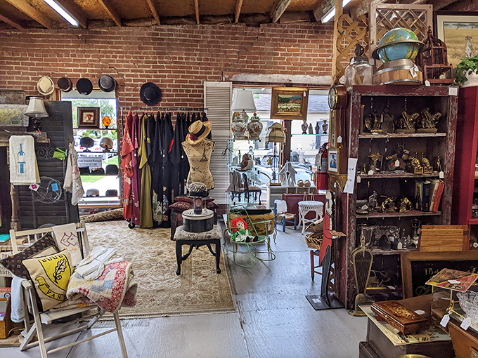 Vintage clothing awaits new life against exposed brick walls, where mannequins stand sentinel over fashion treasures from bygone decades.