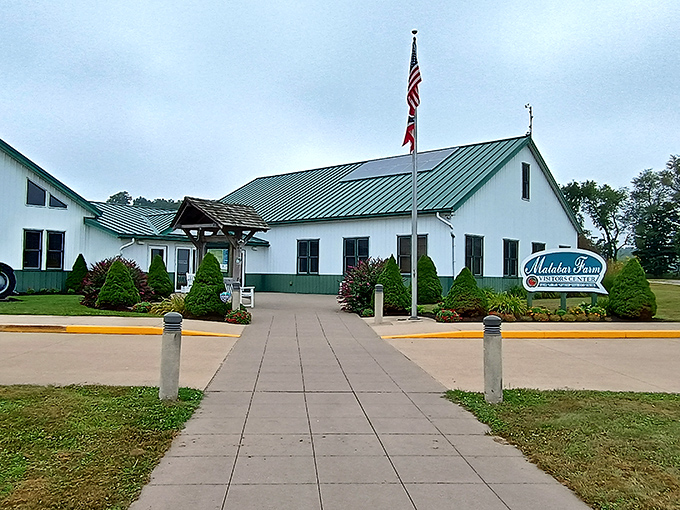 The visitor center welcomes explorers with its clean white facade and American flag &ndash; your gateway to discovering Malabar's agricultural wonderland.