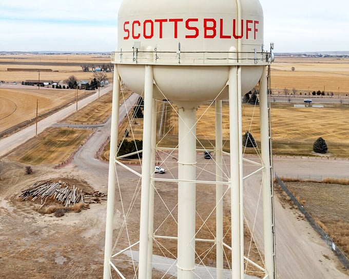 The iconic Scottsbluff water tower stands sentinel over golden Nebraska plains, announcing to visitors they've arrived somewhere authentically American.