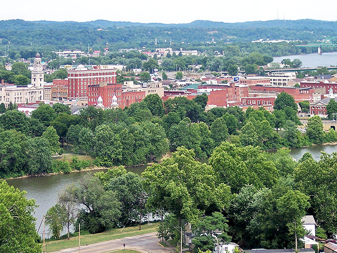 The confluence of the Ohio and Muskingum rivers cradles Marietta in a green embrace, the brick buildings rising like islands from a sea of trees.