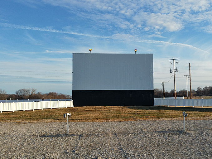 The iconic white screen stands sentinel against a blue sky, patiently waiting for darkness to transform into a portal to other worlds.