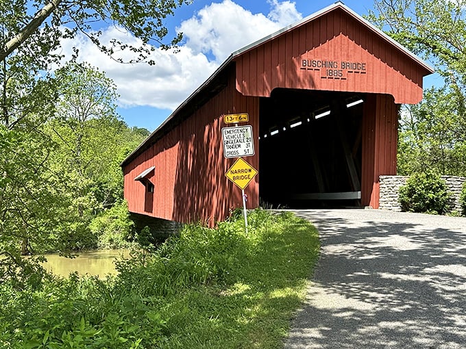 Busching Bridge stands as a crimson sentinel from 1885, inviting travelers to cross into a simpler time.