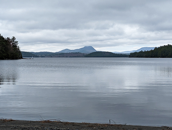 Borestone Mountain reflects in Sebec Lake's mirror-like surface, creating that rare moment when reality outperforms the postcard version.