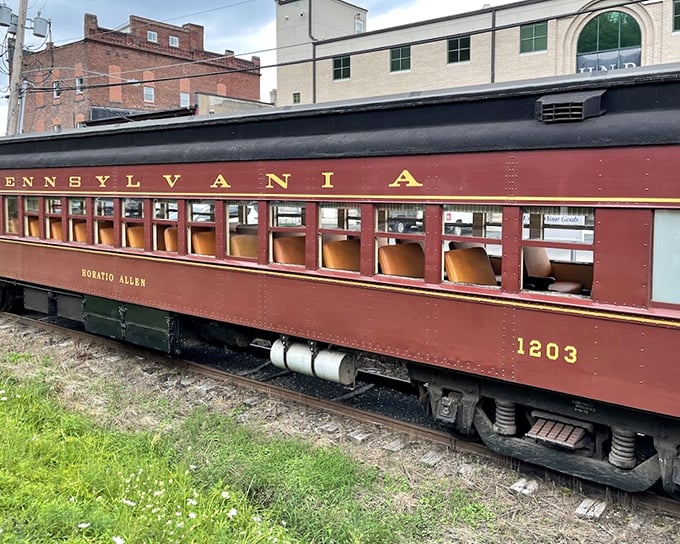 Gleaming in the sunlight, this vintage Pennsylvania 9880 locomotive stands ready for adventure, its black and gold livery a testament to an era when travel was an occasion.