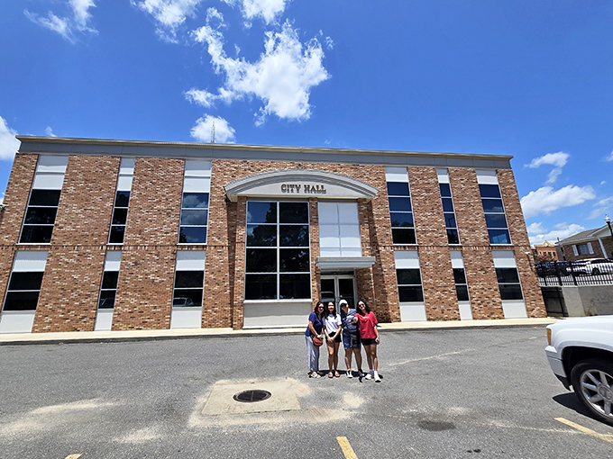 City Hall stands proudly in brick splendor, less a government building and more a community living room with paperwork.