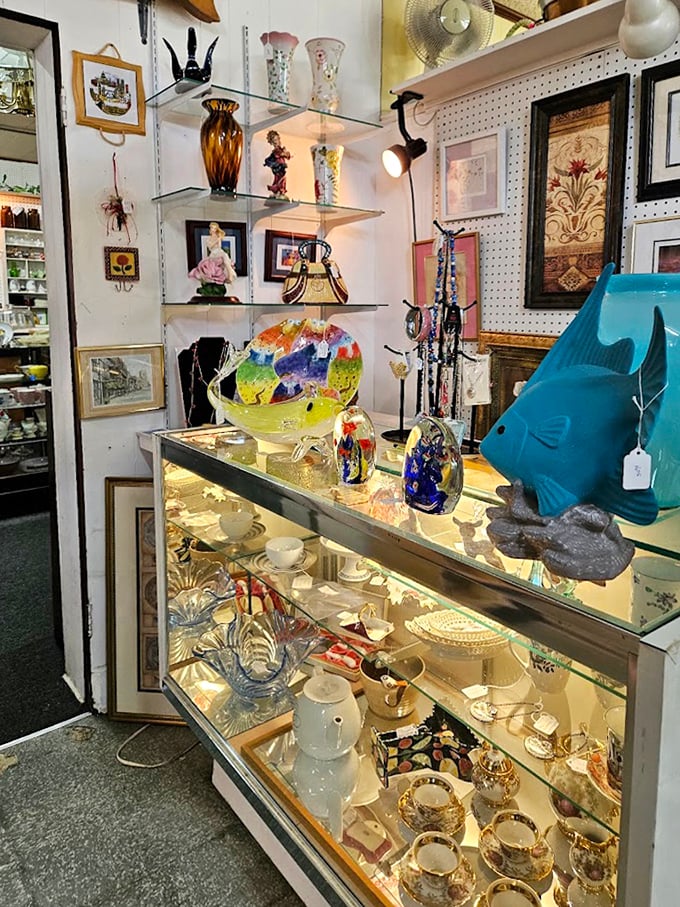 Glass cases gleaming with colorful treasures &ndash; from art glass to figurines. That blue fish seems to be swimming through decades of carefully curated memories.