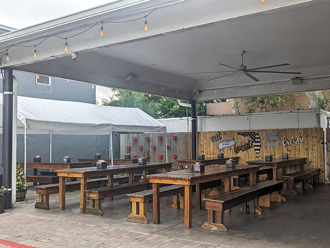 Picnic tables under string lights create that "fancy casual" vibe where you can have a religious barbecue experience without dressing for church.