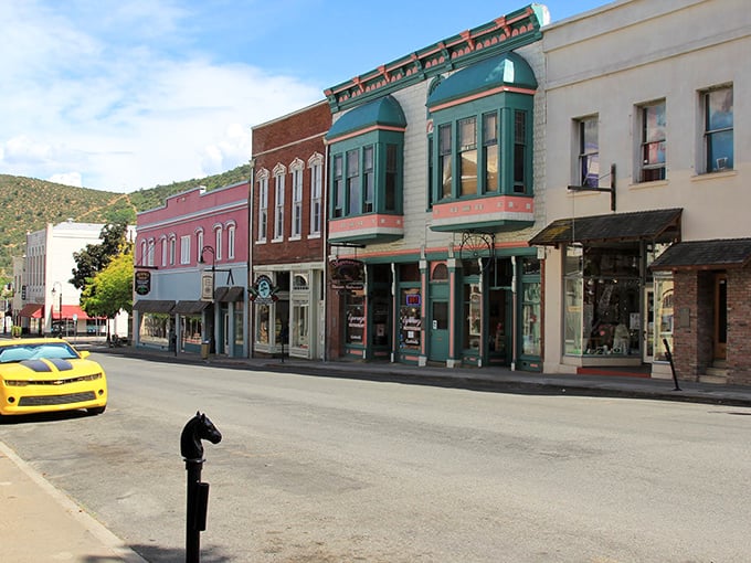 Historic facades in candy-colored hues line Miner Street, where a yellow Camaro feels almost anachronistic against the Gold Rush-era architecture.