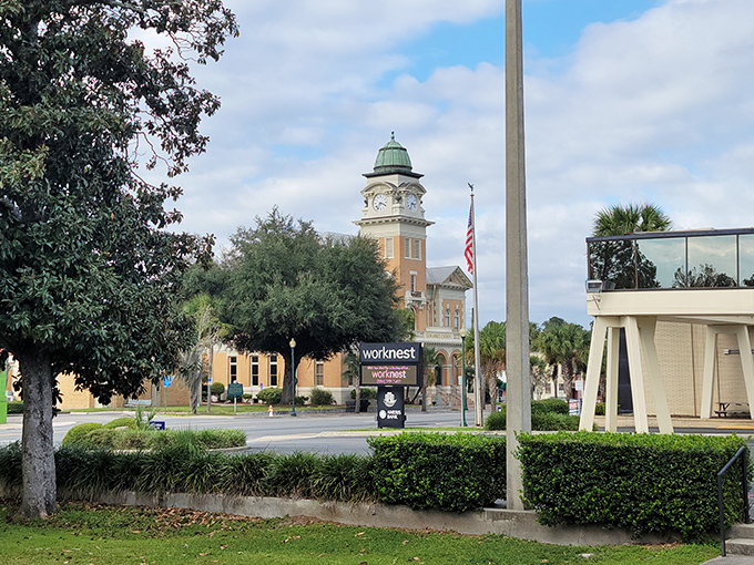 The Suwannee County Courthouse stands like a Victorian timekeeper, its clock tower reminding everyone that in Live Oak, there's always time for a neighborly chat.