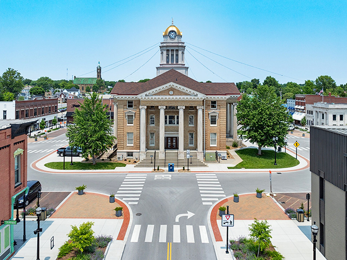 The Dubois County Courthouse commands the town square with its golden dome gleaming in the Indiana sunshine like a beacon of small-town prosperity.