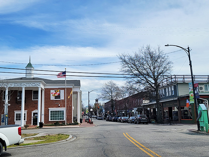 The Denton Town Office stands proudly against blue skies, a brick sentinel watching over the quiet streets of this affordable Eastern Shore gem.