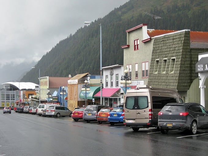Colorful storefronts huddle beneath mountains like children at storytime, creating a downtown where even errands feel like adventures.