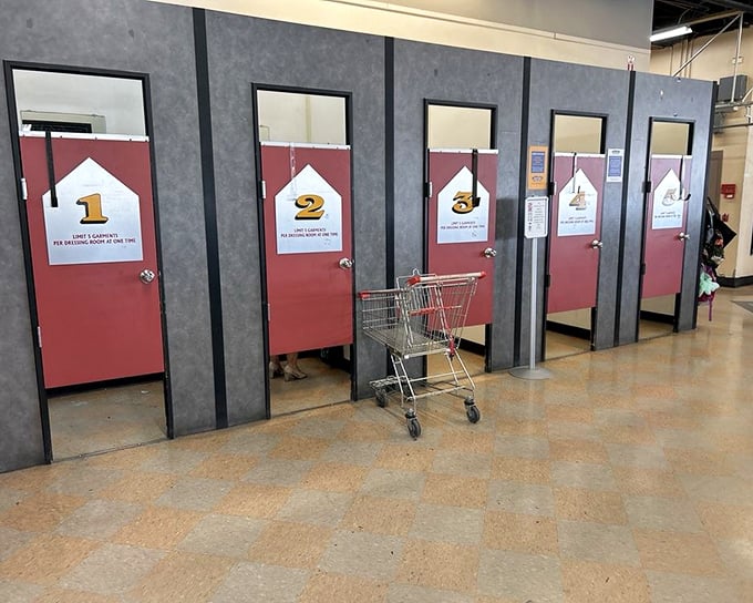 Fitting rooms numbered like chapters in your thrifting adventure story. That shopping cart waits patiently for its next mission.