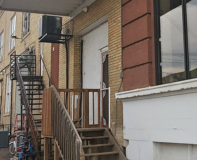 The unassuming entrance hides the magnitude of wonders within, like finding Narnia behind an ordinary wardrobe door.